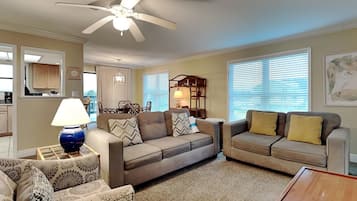 Apartamento em Condomínio Fechado, várias camas, varanda, vista para o oceano | Sala de estar | Televisor