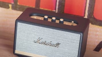 Um amplificador Marshall antigo sobre uma superfície de madeira.