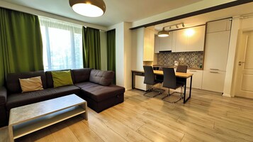 Apartamento urbano, 1 cama King e sofá-cama, para não fumantes | Área de estar | TV 102 cm com canais a cabo, Netflix, serviços de streaming