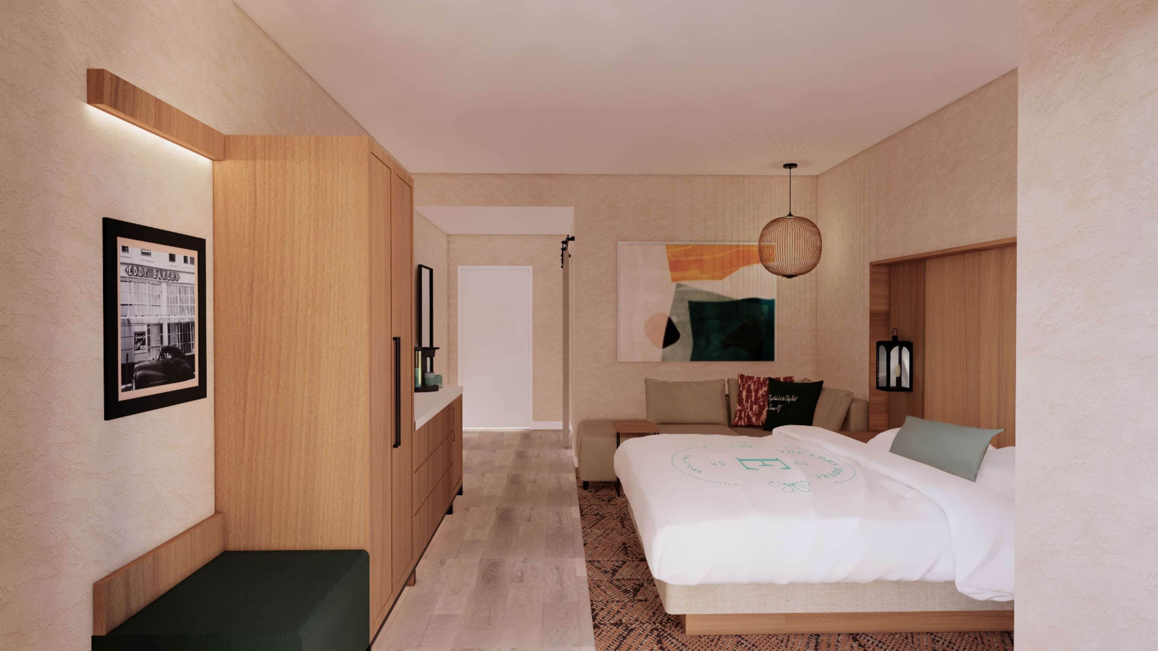 Quarto de hotel moderno com cama, um banco, um guarda-roupa e uma pintura na parede.
