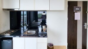 Uma cozinha compacta com máquina de lavar louça embutida, pia e fogão.