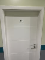 A white door with the label "E2" and a keyhole lock.