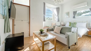 Quarto moderno com cama, mesa de cabeceira e janela com cortinas.