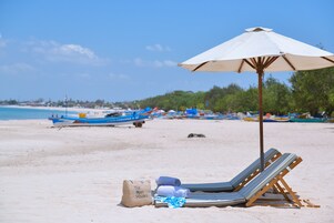 Perto da praia, praia de areia branca, espreguiçadeiras 