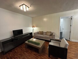 Quarto executivo, 2 quartos | Área de estar | TV