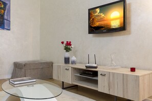 Apartamento Exclusivo, 1 quarto | Sala | TV de ecrã plano, leitor de DVD 
