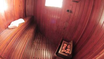 Uma sala de sauna com paredes e bancos de madeira.