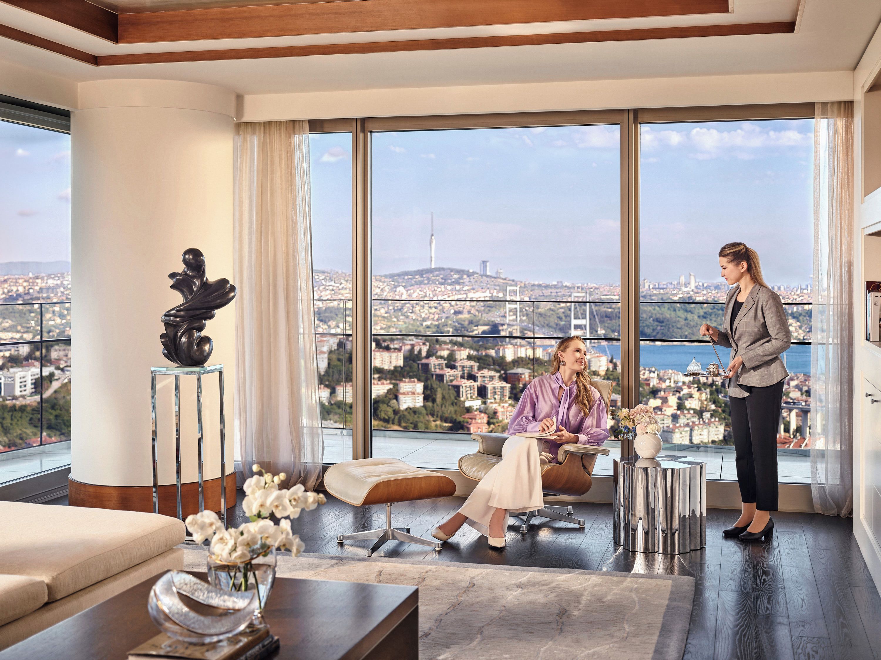 Quarto espaçoso com grande janela e vista para a cidade, área de estar aconchegante e design de interiores moderno.