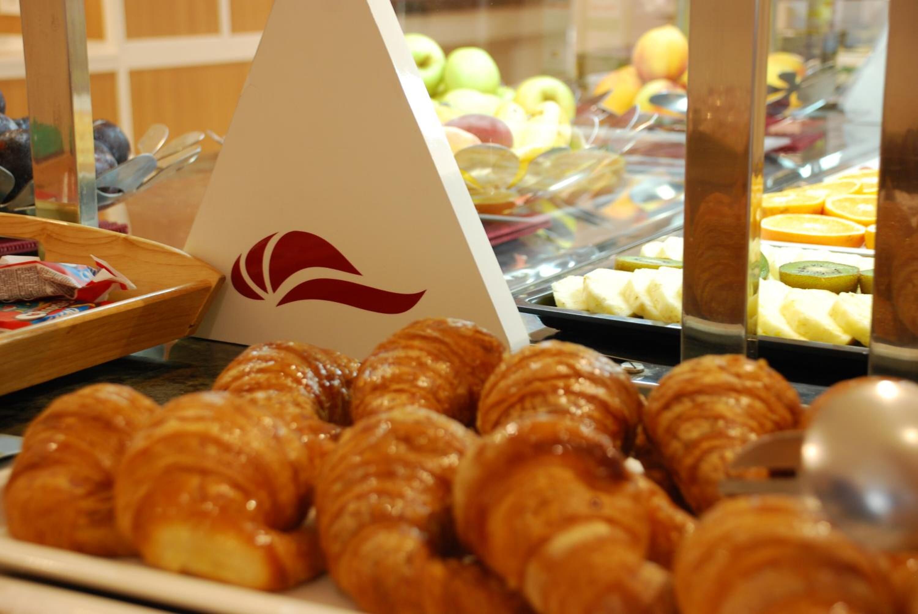 Uma variedade de doces e frutas em uma área de pastelaria.