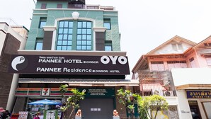 Um hotel com uma grande placa indicando Pannnee Residence, no Dinsor Hotel.