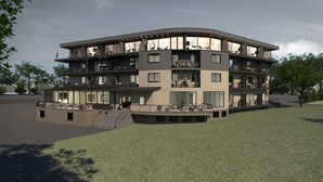 Um edifício residencial moderno de vários andares, com varandas, área de estar ao ar livre e telhado plano.