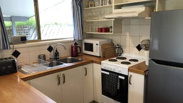 Casa de Campo (Beachwalk 3 Bedroom Cottage) | Cozinha privada | Um frigorífico/congelador grande, um micro-ondas, um forno
