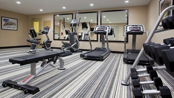 Academia com esteiras, elípticos e aparelhos de musculação.