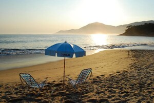 Perto da praia, areia branca, guarda-sóis 
