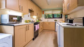 Um frigorífico, uma máquina de lavar louça, utensílios de cozinha