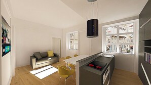 Cozinha moderna com ilha central, área de jantar com mesa branca e cadeiras amarelas, e sala de estar com sofá e janela com vista para edifícios.