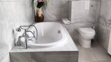 Quarto Duplo Deluxe | Casa de banho | Um polibã, toalhas fornecidas