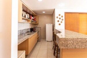 Um frigorífico, um micro-ondas, um forno, uma placa de cozinha