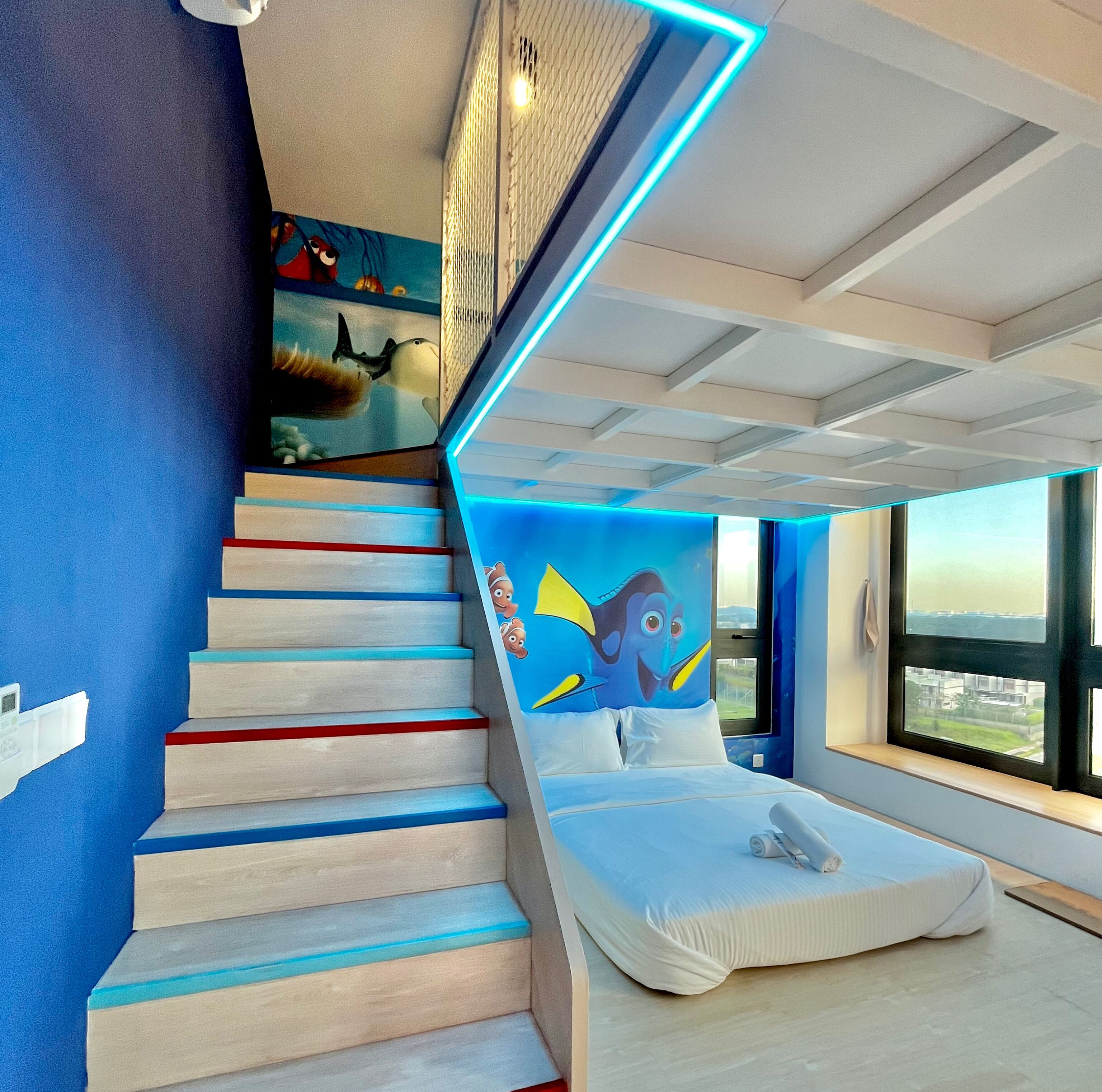 Quarto com cama, janela e escadaria com mural.