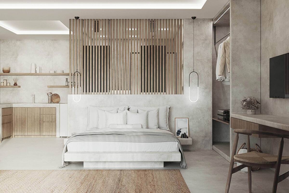 Um quarto moderno com cama, mesas de cabeceira, escrivaninha e guarda-roupa.