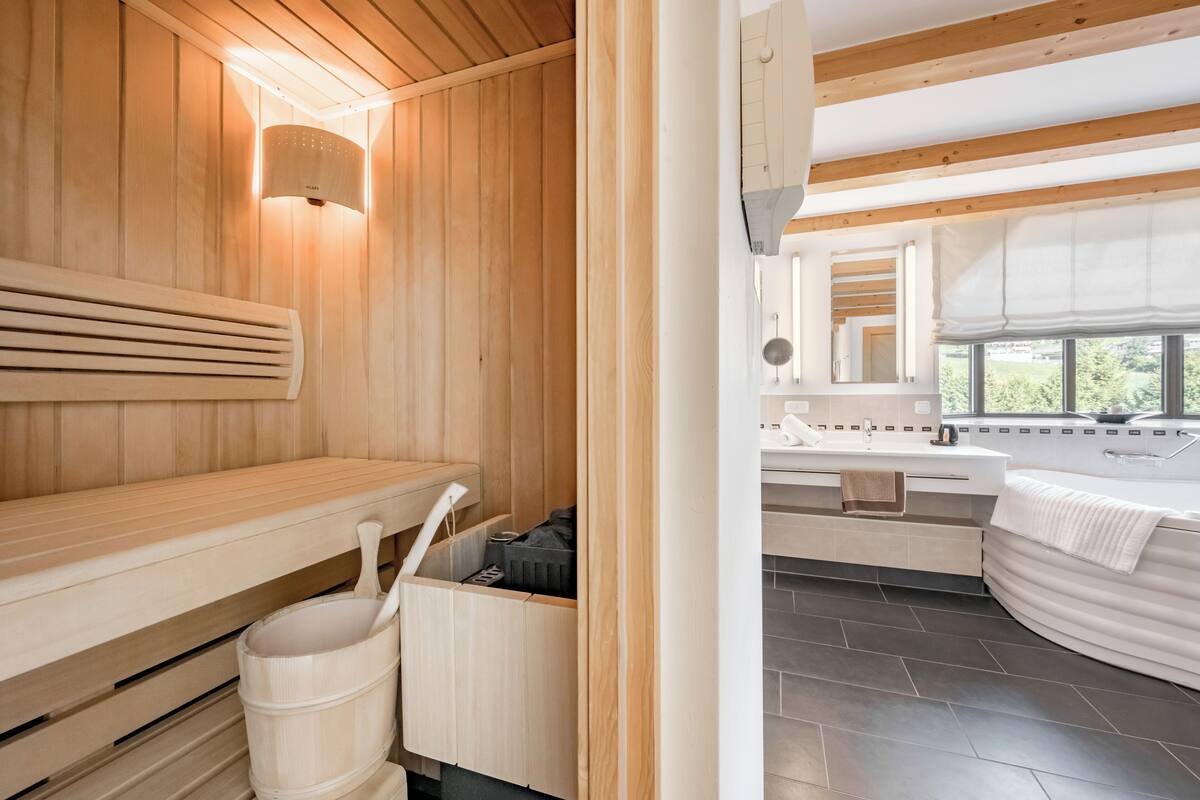 Uma sala de sauna com bancos de madeira e um balde.