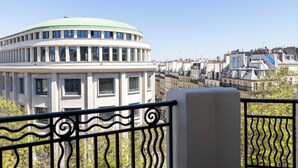 Um edifício com uma cúpula e várias janelas, rodeado por outros edifícios.