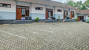 Um edifício com telhado de telhas, várias portas e janelas.