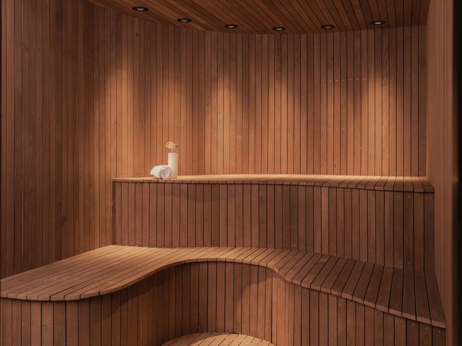 Uma sauna de madeira com bancos e um dispensador de toalhas.