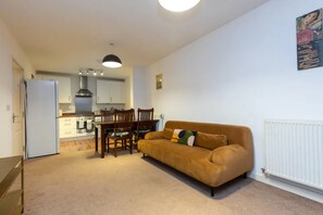 Apartamento básico, 1 cama King | Área de estar | TV