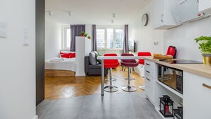 Cozinha moderna com área de refeições, um sofá e vista para a cidade.
