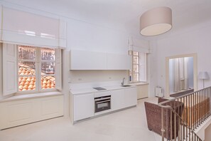 Apartamento Deluxe | Cozinha privada | Um frigorífico/congelador grande, um forno, uma placa de cozinha 