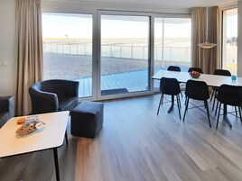 Quarto moderno com uma grande porta de vidro deslizante que dá para uma varanda com vista para uma ponte.