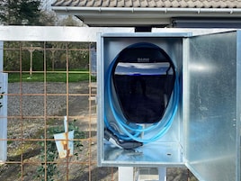Caixa elétrica externa com um cabo azul conectado.