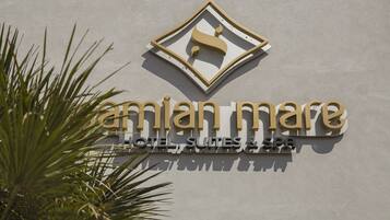 Placa de hotel com logotipo e o nome 'Amian Mare Hotel, Suites & Spa'.