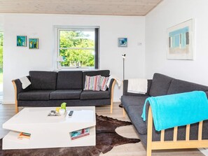Uma sala de estar moderna com sofá, mesa de centro e tapete.