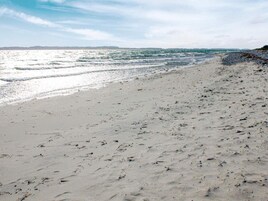 Uma praia com areal e ondas.