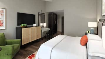 Quarto de hotel com cama, poltrona verde, escrivaninha com cadeira, guarda-roupa, televisão de tela plana e mesa de cabeceira com abajur.