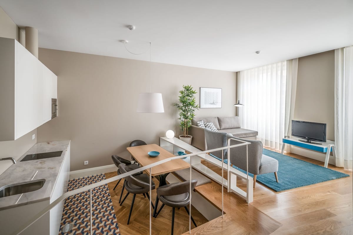 Um apartamento moderno com cozinha, sala de jantar e sala de estar.