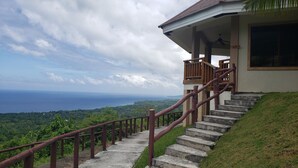 Escadaria que leva a um edifício com vista para o oceano.