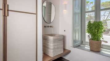 Villa Design | Casa de banho | Um polibã, um chuveiro de hidromassagem, um secador de cabelo, chinelos