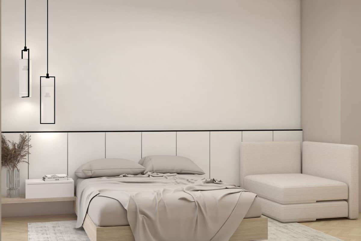 Um quarto moderno com cama, mesa de cabeceira, puf e sofá.