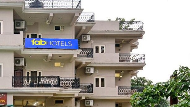 Um edifício de vários andares com uma placa indicando 'Fab Hotels'.