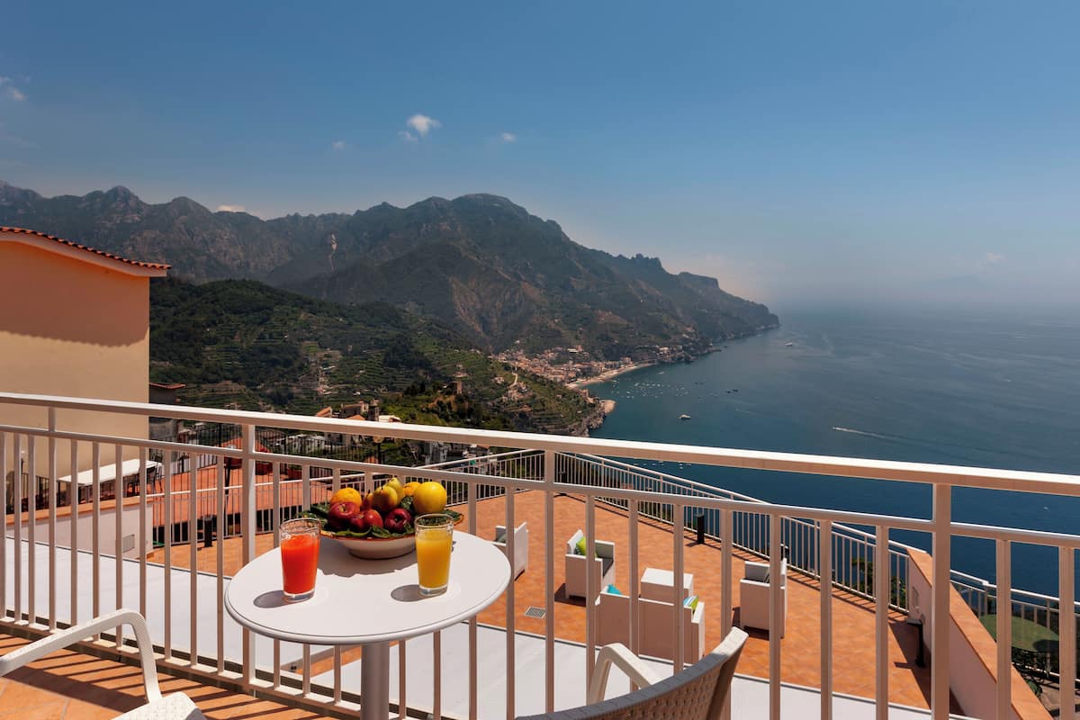 Quarto romântico, sacada, vista para o mar | Frigobar, cofres nos quartos, escrivaninha
