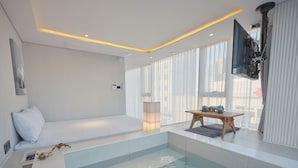 Um banheiro moderno com uma banheira de hidromassagem com cobertura de vidro, um banco de madeira e um espelho grande.