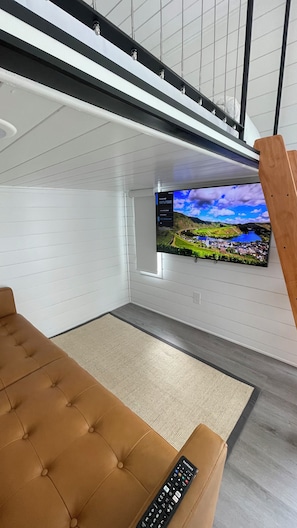 Suíte estúdio design, 1 cama Queen, varanda, no pátio | Área de estar | Smart TV 50 polegadas com canais digitais