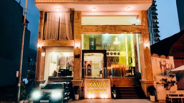 Um hotel com uma placa grande no topo com a inscrição 'XAVIA HOTEL'.