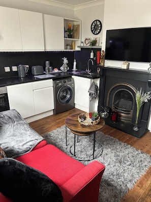 Apartamento, 1 cama Queen e sofá-cama | Área de estar