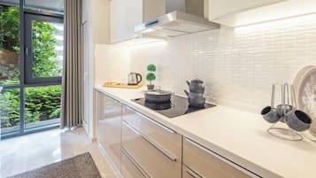 Apartamento Deluxe, 3 quartos, varanda | Cozinha privada | Um frigorífico, um micro-ondas, um forno, uma placa de cozinha