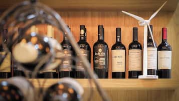 Uma adega com garrafas rotuladas 'Laretis' e 'Salvattore', com um fundo de madeira.