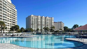 Uma área de piscina com um edifício grande ao fundo.